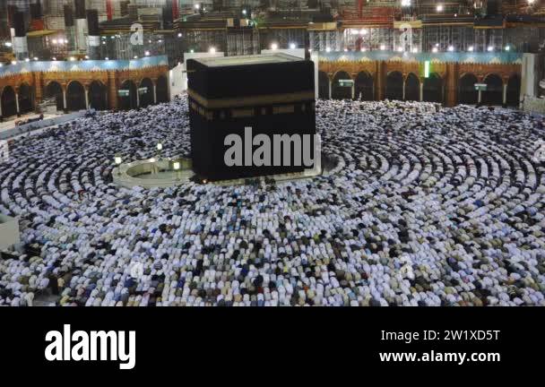 Muslim pilgrims bow and prostrate during evening prayer facing the ...