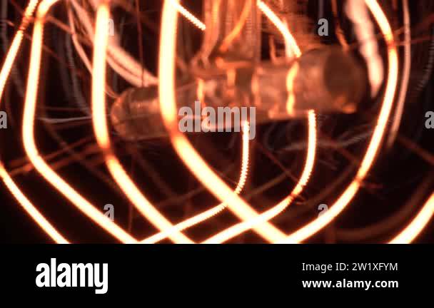 Extreme macro inside of Edison light bulb slowly reveal in focus and ...