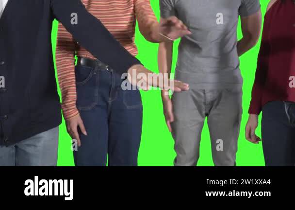 Top view of young people joining their hands together showing unity and teamwork. Shot in 4k ...