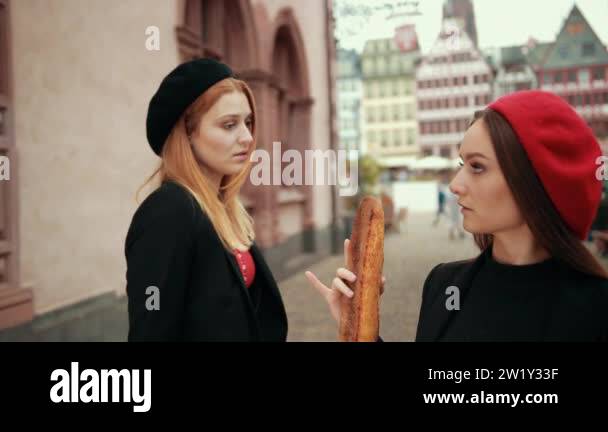 Two beautiful French women in black jackets and red beret fight with ...