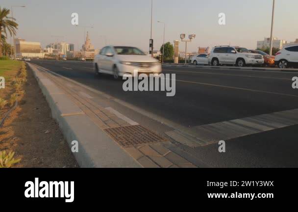 Corniche street in Doha Qatar afternoon low angle shot showing cars ...