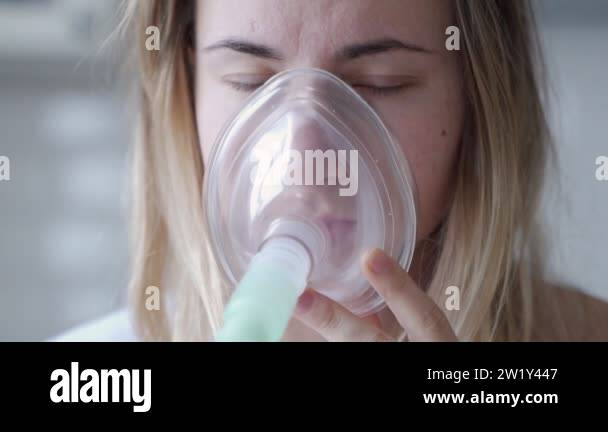 Woman uses an inhaler at home when she coughs. Treatment of respiratory ...
