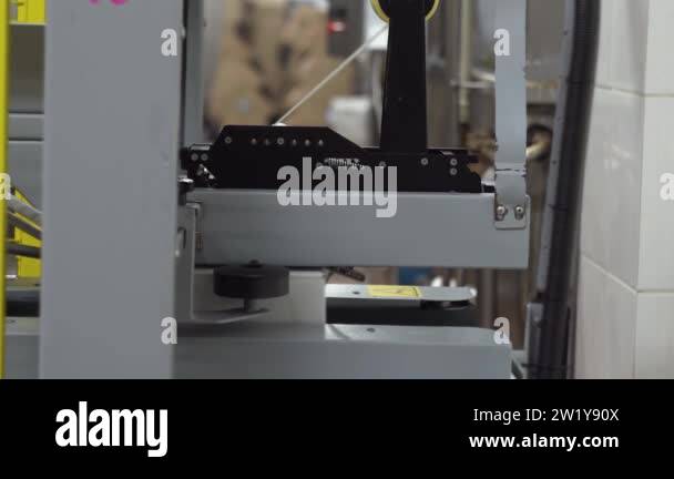 Automatic adhesive taping of a cardboard box on a conveyor belt Stock ...