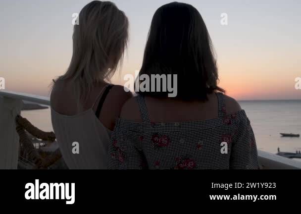 Daughter teenager and mother near the Red Sea meet the dawn. A 45-year ...