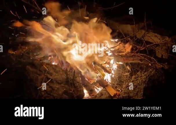 Exciting video of a large blazing bonfire with sparks and particles ...