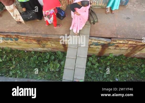 Passengers boarding a river ship at Hularhat Launch Ghat pier ...