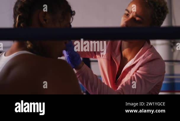 Front view of a mixed race female boxing coach with short curly hair ...