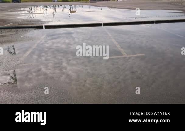 Puddle on tarmac street Stock Videos & Footage - HD and 4K Video Clips ...