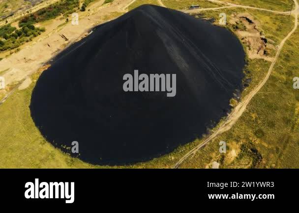 Large mountain of black Slag waste aerial view. Black Slag clinker is ...