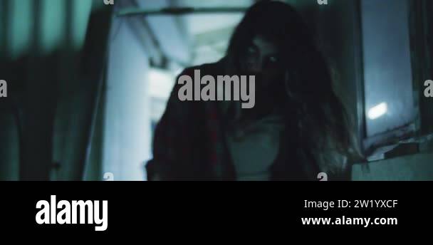 Zombie woman walking outside the building at night. Woman ...