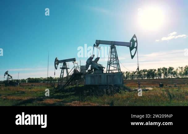 Oil development site with functioning pumping units. Oil well, crude ...