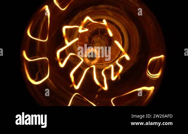 Edison light bulb, slow sliding from the top inside reveals details in ...