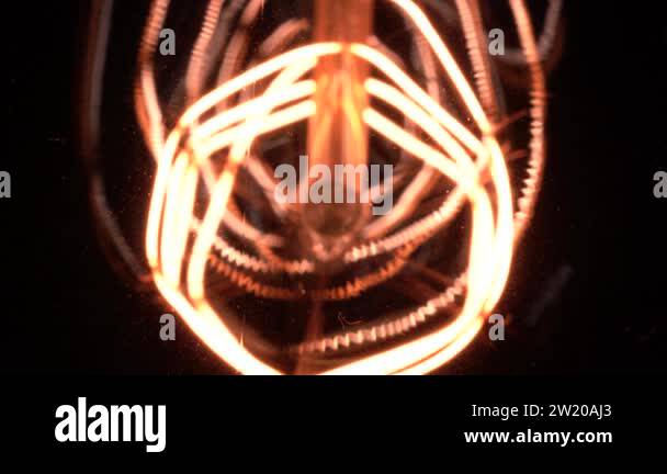 Extreme macro inside of Edison light bulb slowly reveal in focus and ...