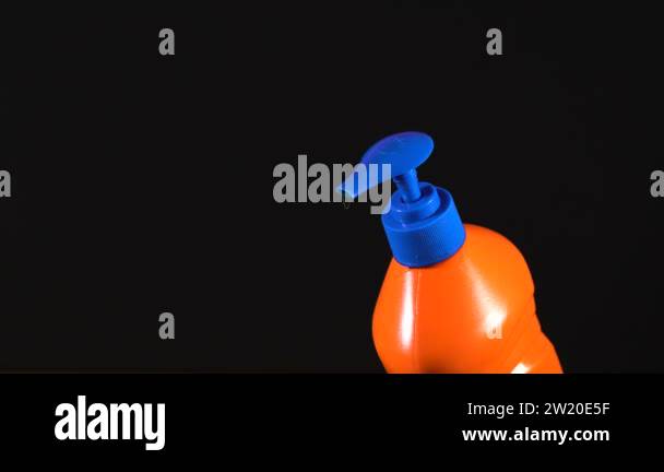 Orange bottle of detergent. Bottle without labels and name. Hand ...