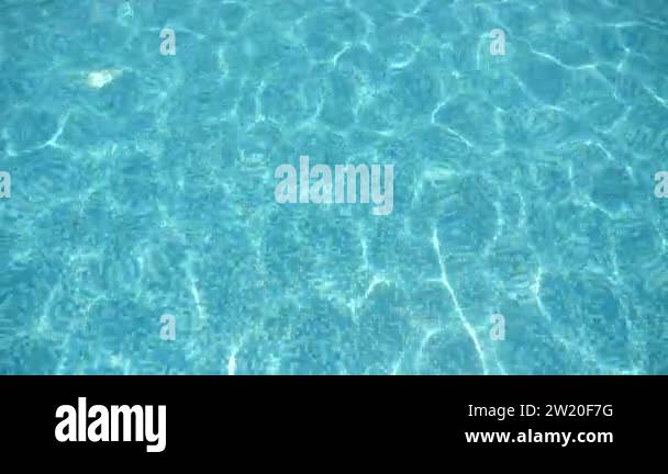 Cheery waves swaying slowly in a wading pool with transparent waters in ...
