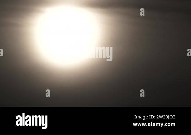 Sun falling through dark, hazy and polluted sky with transition to ...