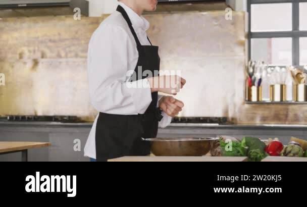 Side view close up of a Caucasian female chef wearing chefs whites ...
