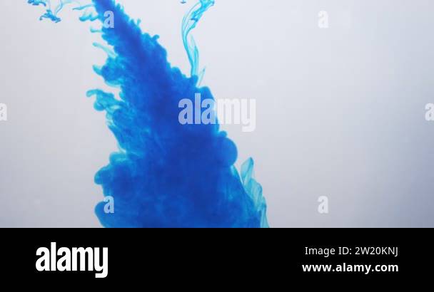 Blue color paint ink drops in water at white background. Inky cloud ...