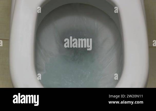 Toilet Flushed Top View. Close-up view of a Water flushing down into ...