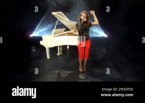 retro lady singer singing jazz in microphone on stage with spotlights ...