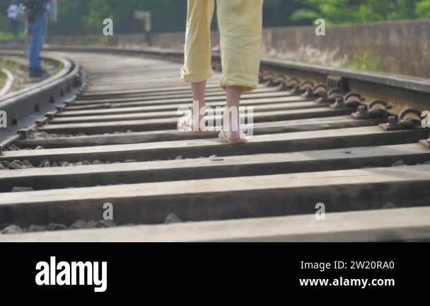 Woman walks along railway track Stock Videos & Footage - HD and 4K ...