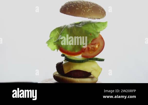 Composition of a large burger, the ingredients individually hang in the ...