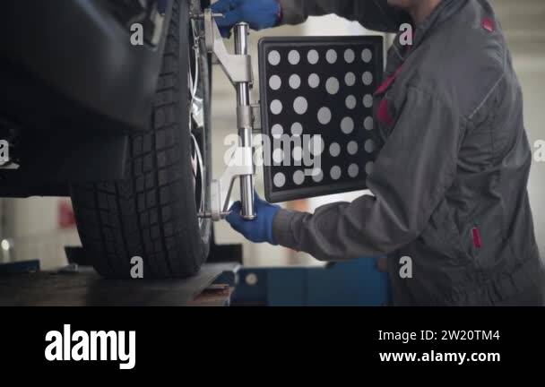 Close-up of male Caucasian auto mechanic coming to car, adjusting ...