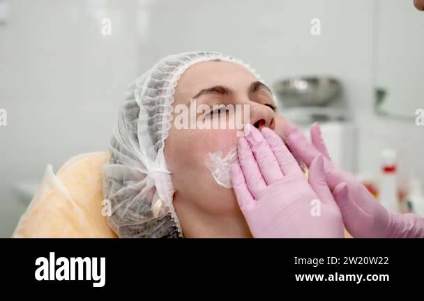 Doctor cosmetologist putting plastic film on cream with anesthesia on ...
