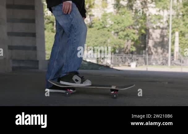 Professional extreme athlete rides skateboard and does various tricks ...