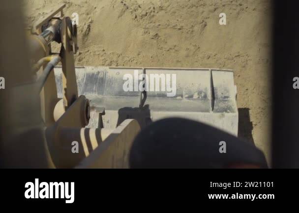 Drivers POV of sand picking on outdoor manufacturing site. Bucket of ...