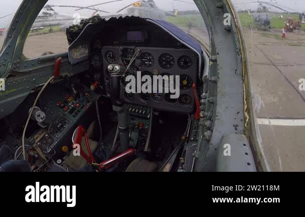 People move a combat fighter plane to a parking spot at the airfield ...