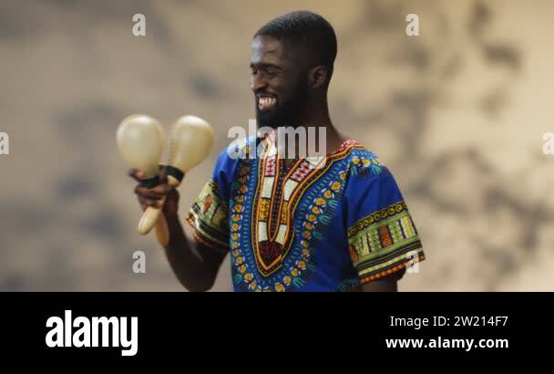 Portrait of handsome young African American man in traditional clothes ...