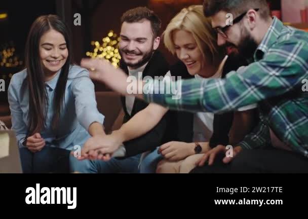 Office team of young people in a modern office center put hands over ...