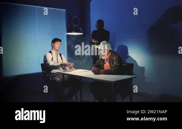 Interrogation room in smoke: detective showing evidence of drug ...