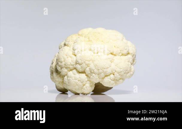 Fresh raw Cauliflower with shadow on a white table, rotation 360 ...