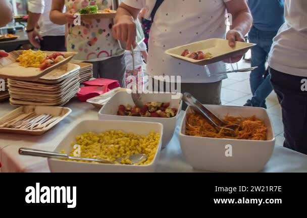 Guests at an event at a self-service lunch. The variety of food is ...