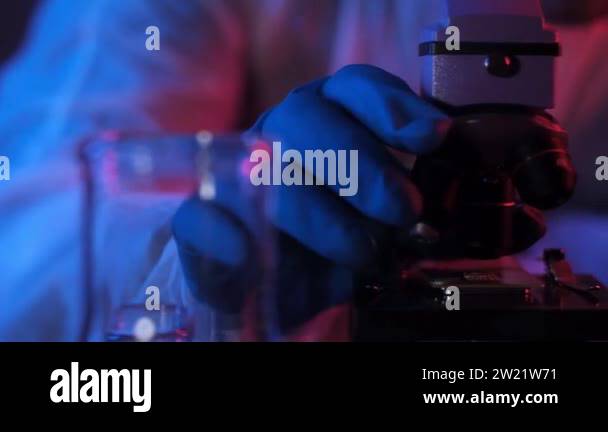 researcher in scientific and technical laboratory with neon light ...