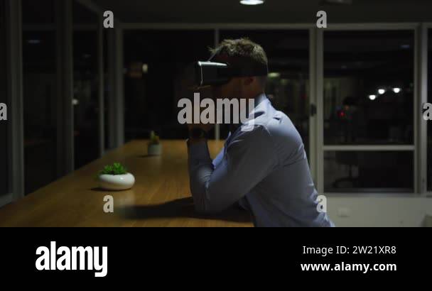 Side view of a Caucasian businessman working late in a modern office ...
