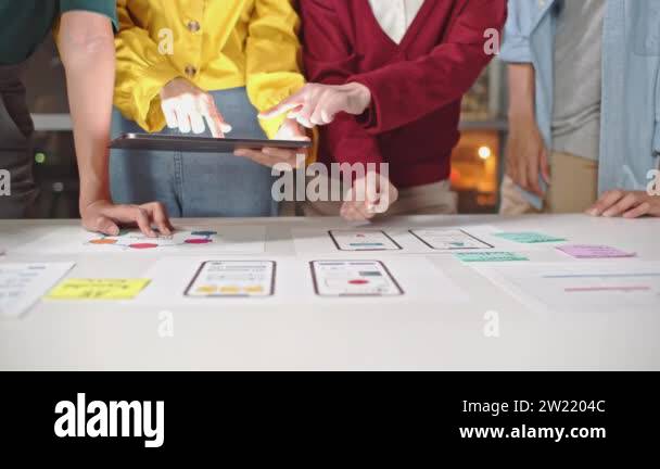 Young Asian business creative developer team work together at night, mobile application software ...