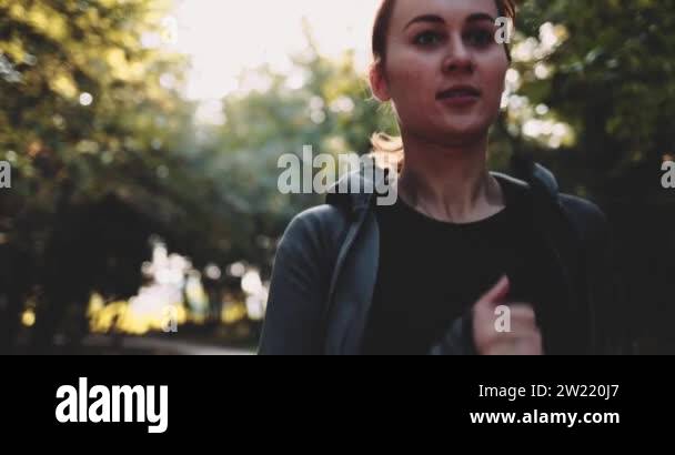 Runner Woman Running in the Sunny City Park Exercising Outdoors. Gimbal ...