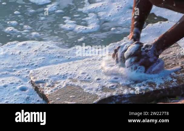 Hands Washing Clothes On The Flat Rock In Varanasi,India With Soap ...