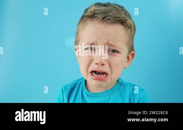 Concept of emotion. Little boy suddenly burst into tears. Child can not ...