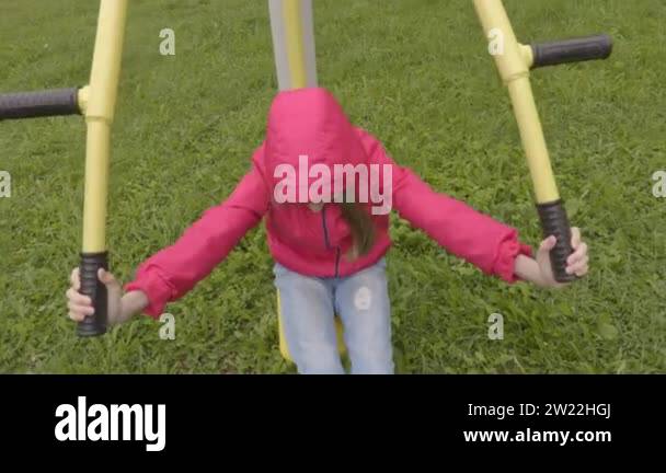 Little girl try huge exercise machine Stock Video Footage - Alamy