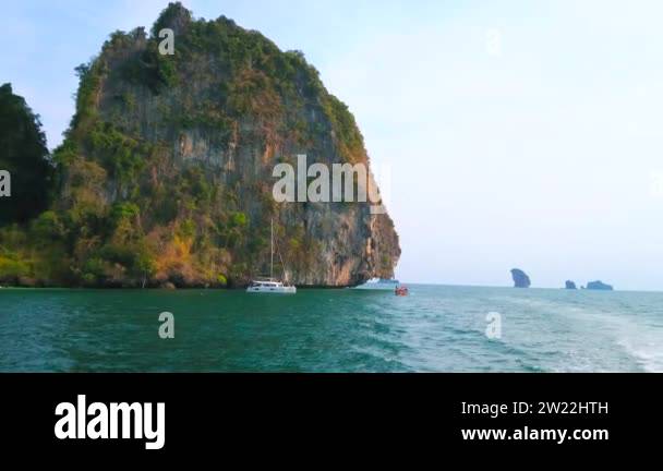 Admire tall steep rocky cliffs of Koh Poda Island, surrounded by deep ...