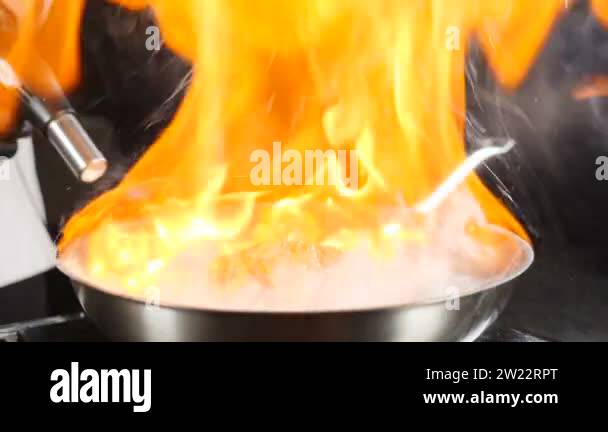Chef making steak fillet mignon in flambe style on a grill pan. Cooking ...