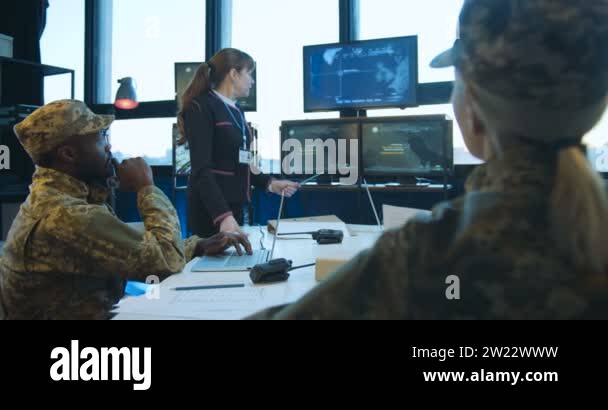 Woman rulling at military monitoring meeting while standing at table ...