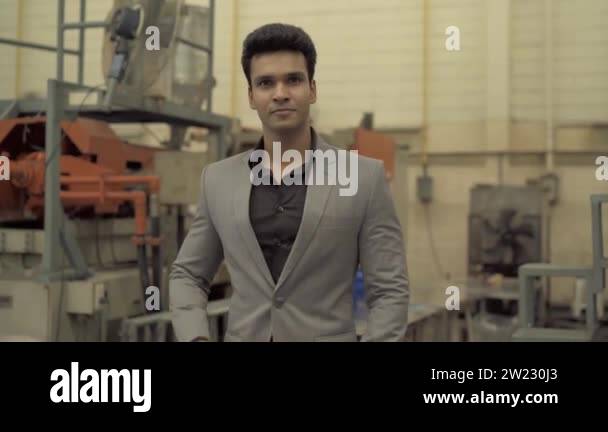 Young 20s Indian Asian factory business owner posing for a camera in ...