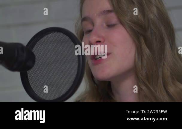Singer teenager girl is training to make music in track recording ...