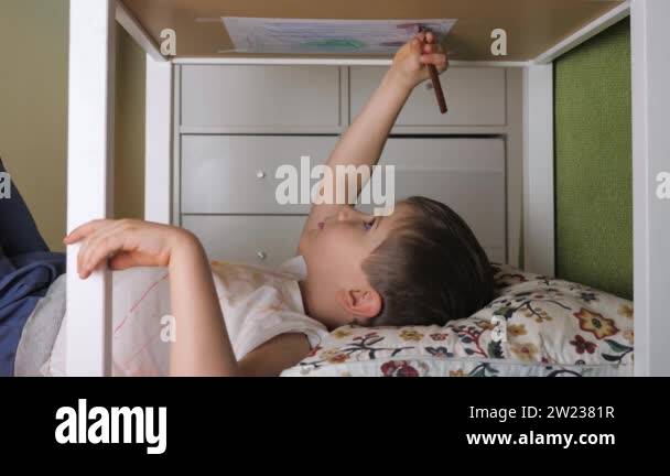 Boy painting upside down. Leisure activity at home, indoor. Preschooler ...