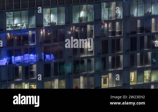 Night view of exterior apartment tower timelapse. High rise skyscraper ...